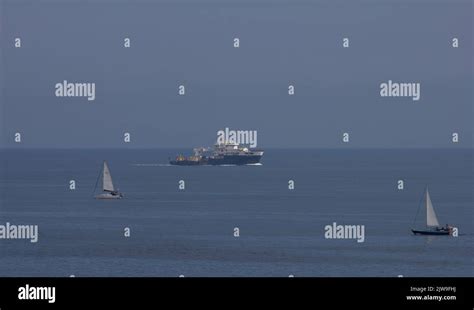 Sail And Power Sailing Ships Passing A Ship In Coverack Bay Cornwall