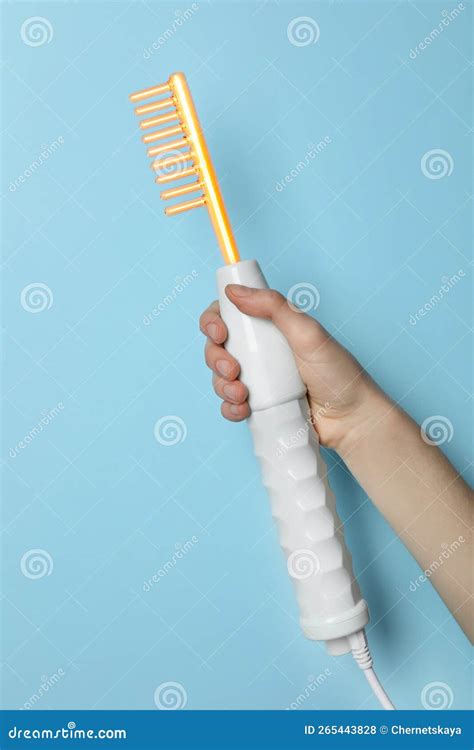 Woman Holding Working High Frequency Darsonval Device on Light Blue ...