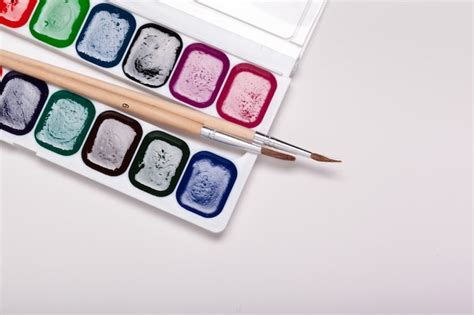 Premium Photo Paper Watercolors Paint Brush And Some Art Stuff