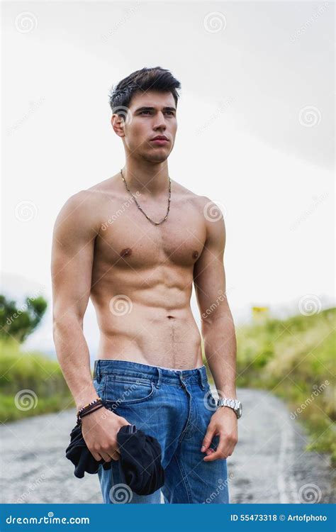 Shirtless Muscular Man And Cute Athletic Woman On The Beach Stock