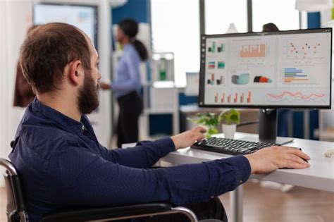 free photo invalid worker with disabilities working at computer