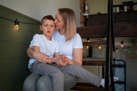 Premium Photo Mother Taking Care Of Her Autistic Son At Home