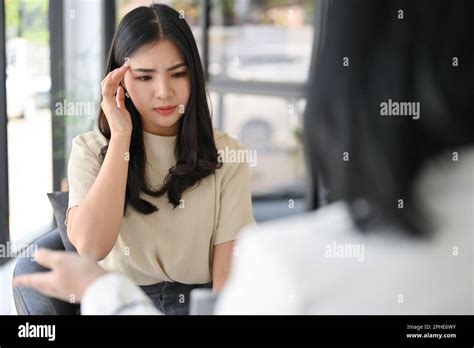 Stressed And Thoughtful Millennial Asian Woman Feeling Dizzy And