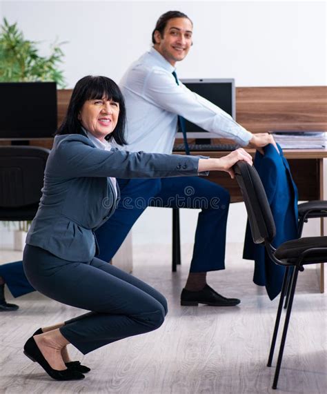 Two Employees Doing Sport Exercises In The Office Stock Image Image Of Enjoying Employee