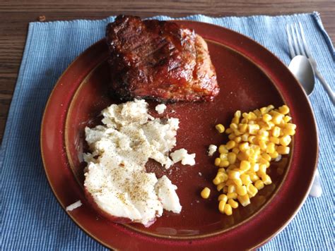 Fruits Of Grilling Bbq Ribs And Grilled Potato With Some Corn Nuked In