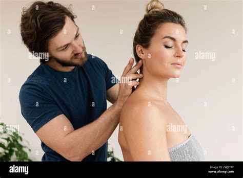 Professional Masseur Using Acupressure Techniques For Clients Neck