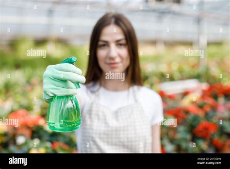 Gartenkonzept Hübsche lächelnde Frau in der Schürze das