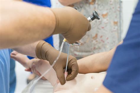 A Team Of Urologist Doctors Performing A Cystoscopy Using A Cystoscope