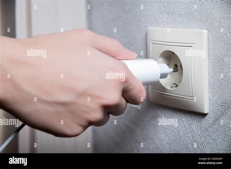 Close Up Of A Woman S Hand Inserting A White Usb Charger Into A Volt Socket Stock Photo Alamy
