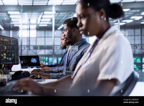 Computer Scientists In Data Center Using Diagnostic Tools And System Monitoring Software To