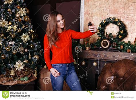 Cheerful Young Woman Taking A Christmas Selfie With Smartphone Stock