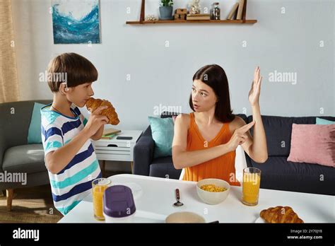 A Mother Uses Sign Language To Communicate With Her Son While Enjoying