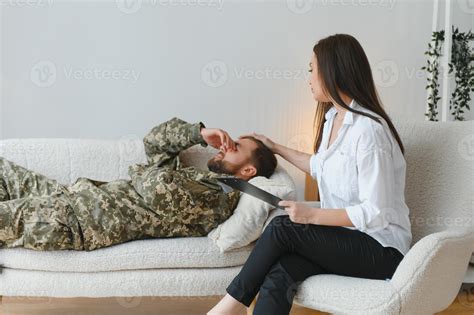 Psychologist Making Notes During Therapy Session With Sad Male Soldier