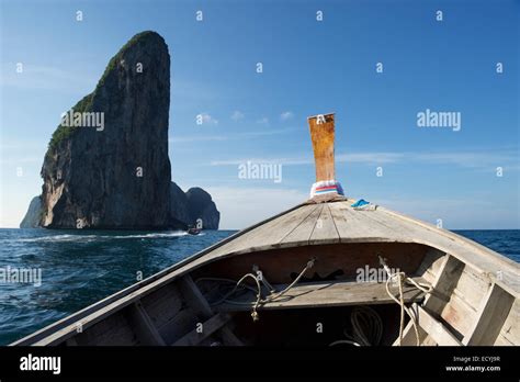 Traditional Thai Wooden Longtail Boat With Dramatic Karst Geography On