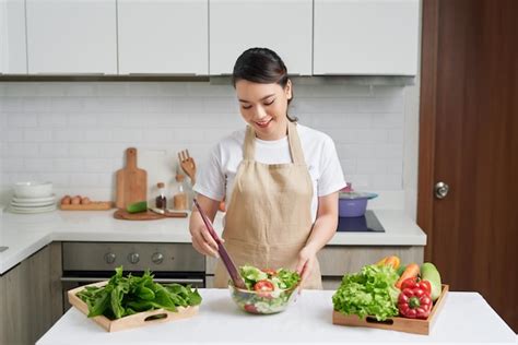 Premium Photo Young Cook Preparing A Salad In Cozy Kitchen