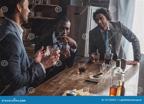 Cropped Shot Of Smiling Multiethnic Businessmen Talking While Smoking
