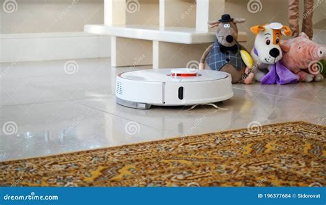 White Robotic Vacuum Cleaner. The Robot Is Controlled By Voice Commands ...