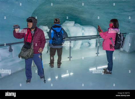 Tourists In The Jungfrau Railway Ice Palace At Jungfraujoch Near