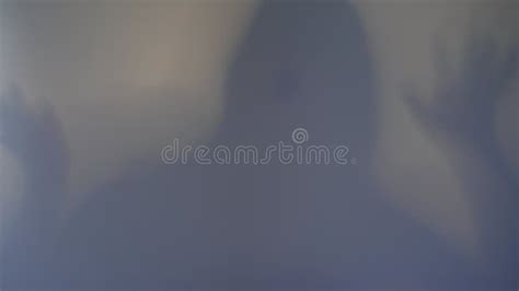 Shadow Blur Of A Horror Man Behind Frosted Glass Blurred Hand Body