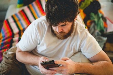 Man Checking Phone By Stocksy Contributor Courtney Rust Stocksy