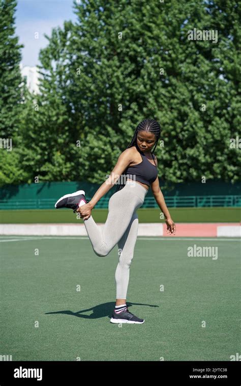 African American Woman Tries To Pump Gluteal Muscles Standing On Left