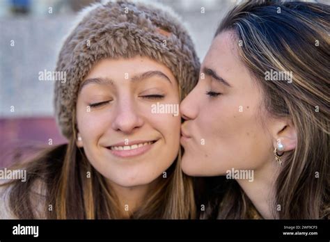 Young Teenager Kissing Her Friend Or Sister With Affection And Emotion