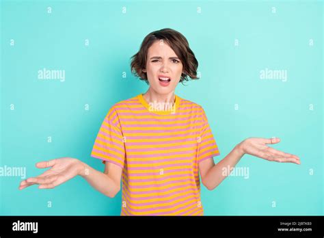 Photo Of Doubtful Puzzled Young Lady Wear Orange T Shirt Shrugging