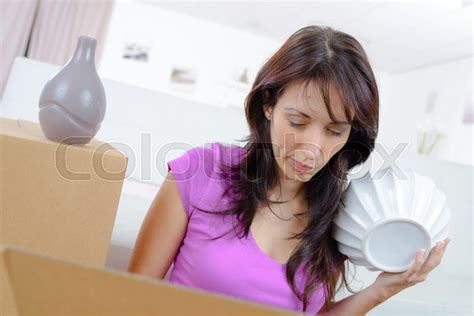 Woman Securing Her Fragile Objects In Stock Image Colourbox
