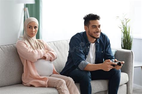 Caring Arab Husband Making Neck Massage To Pregnant Muslim Wife At Home