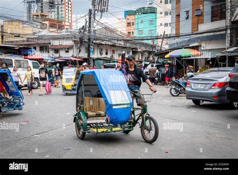 A Tuk Tuk Or Trike Driver Makes His Way Through The Busy Streets Of The
