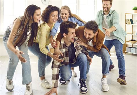 Funny Happy Overjoyed Group Of People Friends Having Fun Playing At