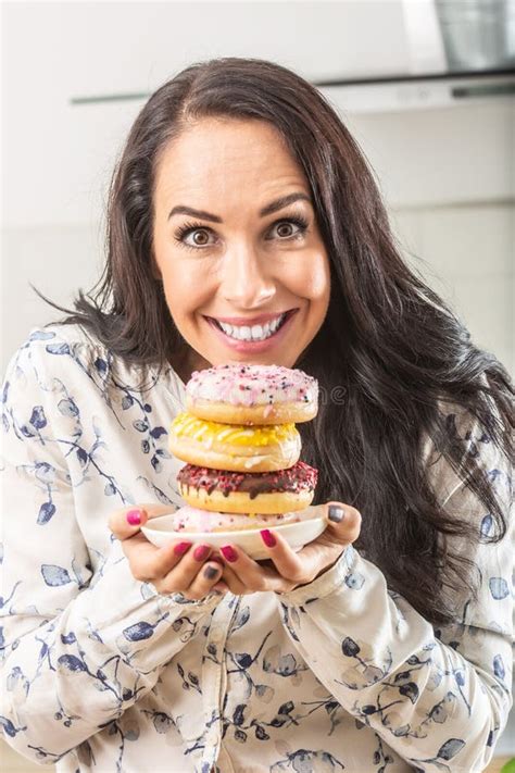 Four Donuts On A Plate Held By A Good Looking Brunette Woman Stock