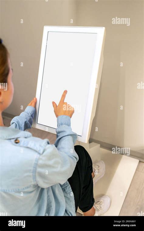 Woman Using Big Digital Touch Screen In Public Place Navigation Check