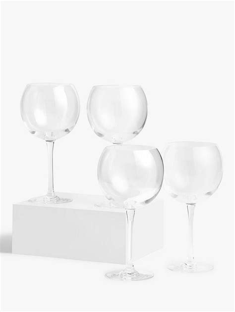 Three Clear Wine Glasses Sitting On Top Of A White Box Next To Each