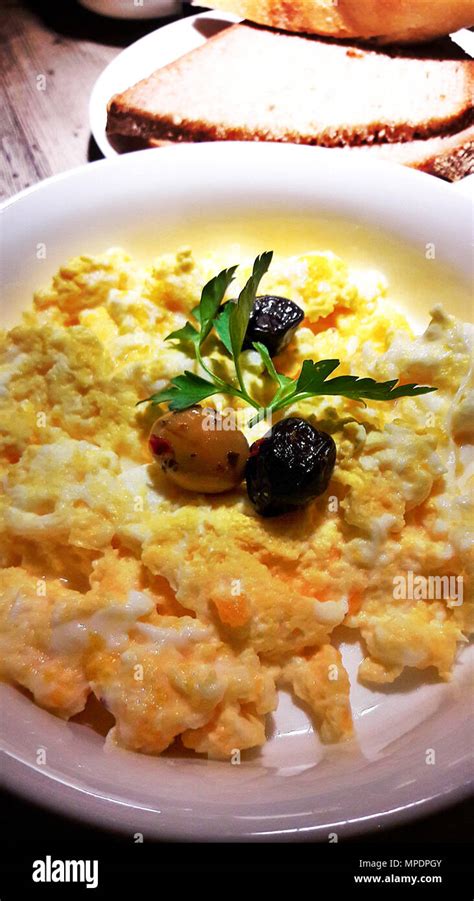 Scrambled Eggs With Olive And Greens In White Plate Breakfast Concept