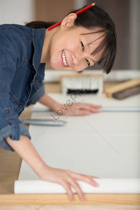 Woman Laying Wallpaper On A Pasting Table Photo Picture And Hd Photos