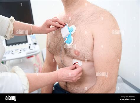 Male Patient With Sensors On His Body To Monitor Arrhythmia Stock Photo Alamy