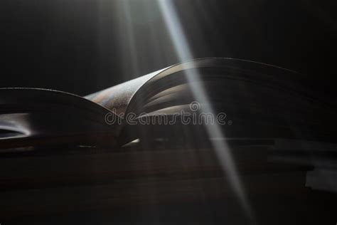 Rays Of Light Fall On The Opened Book The Book Is Illuminated By Light Abstract Photo Of The