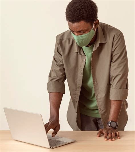 Free Photo Man Using His Laptop And Standing