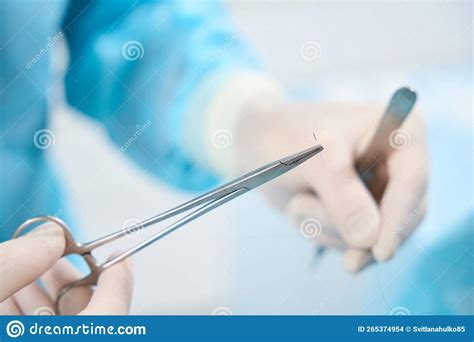 Well Trained Surgeon Operating Medical Suturing Tools With Care And