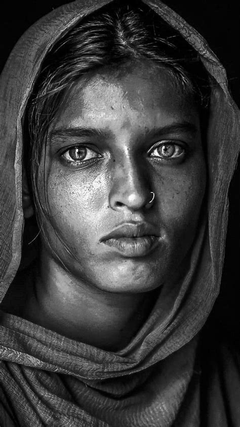 A Black And White Photo Of A Woman With Freckles On Her Face