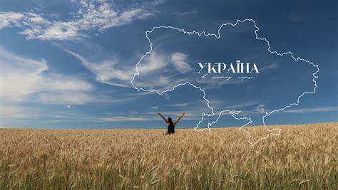 A Person Standing In A Wheat Field With Their Arms Up And The Map Of