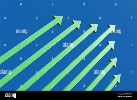 Many Green Up Arrows On Sky Blue Background Illustration Of The
