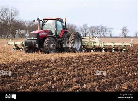 A Case IH Tractor And Field Implement Prepare A Field In Late Spring