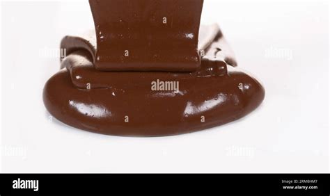 Chocolate Flowing On White Background Stock Photo Alamy