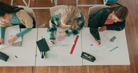 School Above And Students Writing In Classroom For Examination