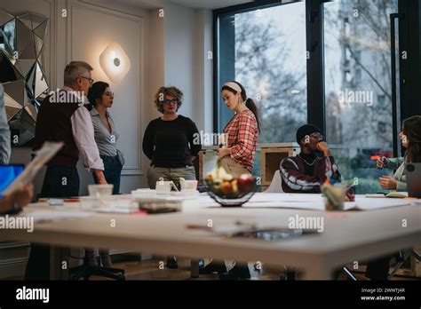 Engaged Colleagues In An Office Environment Focusing On A Project A