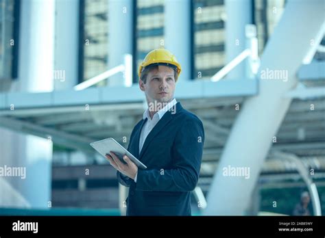 Portrait Of Multiethnic Architect With Blueprints And Business Industrial Man Engineer At