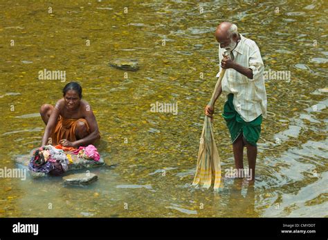 Man And Woman Washing Clothes In Menik Ganga River At This Sacred Multi