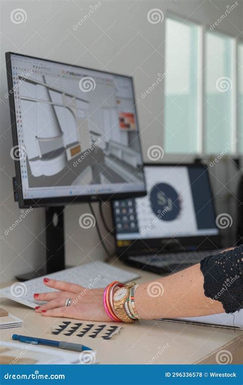 Female Graphic Designer Multitasking On Two Computing Devices Sitting